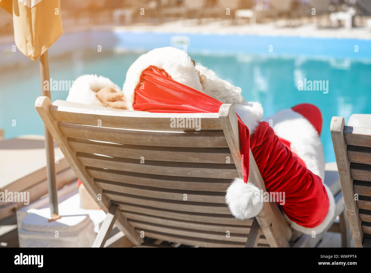Santa Claus resting near swimming pool at resort Stock Photo - Alamy