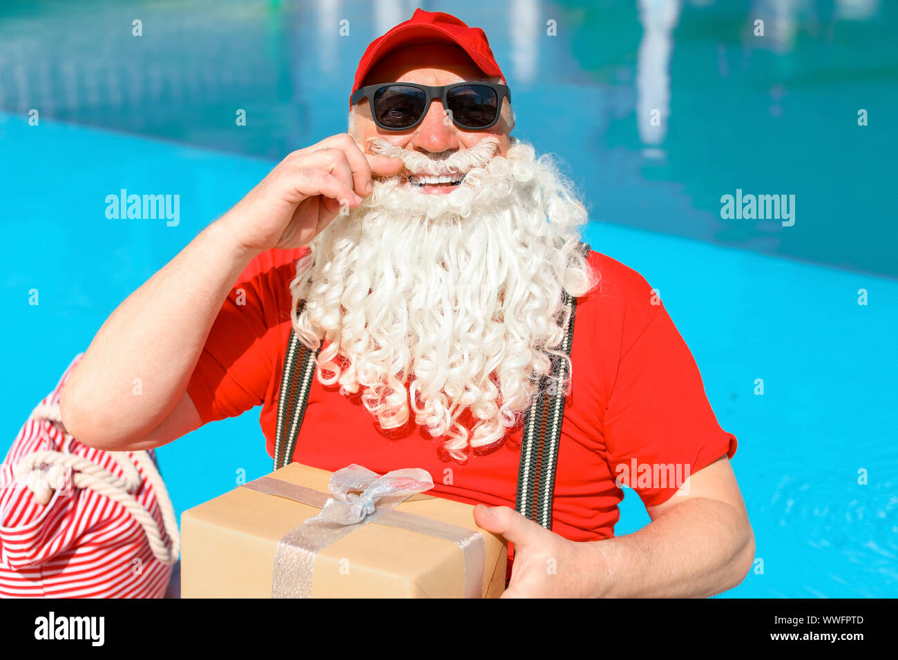 Santa Claus with gifts near swimming pool at resort Stock Photo - Alamy