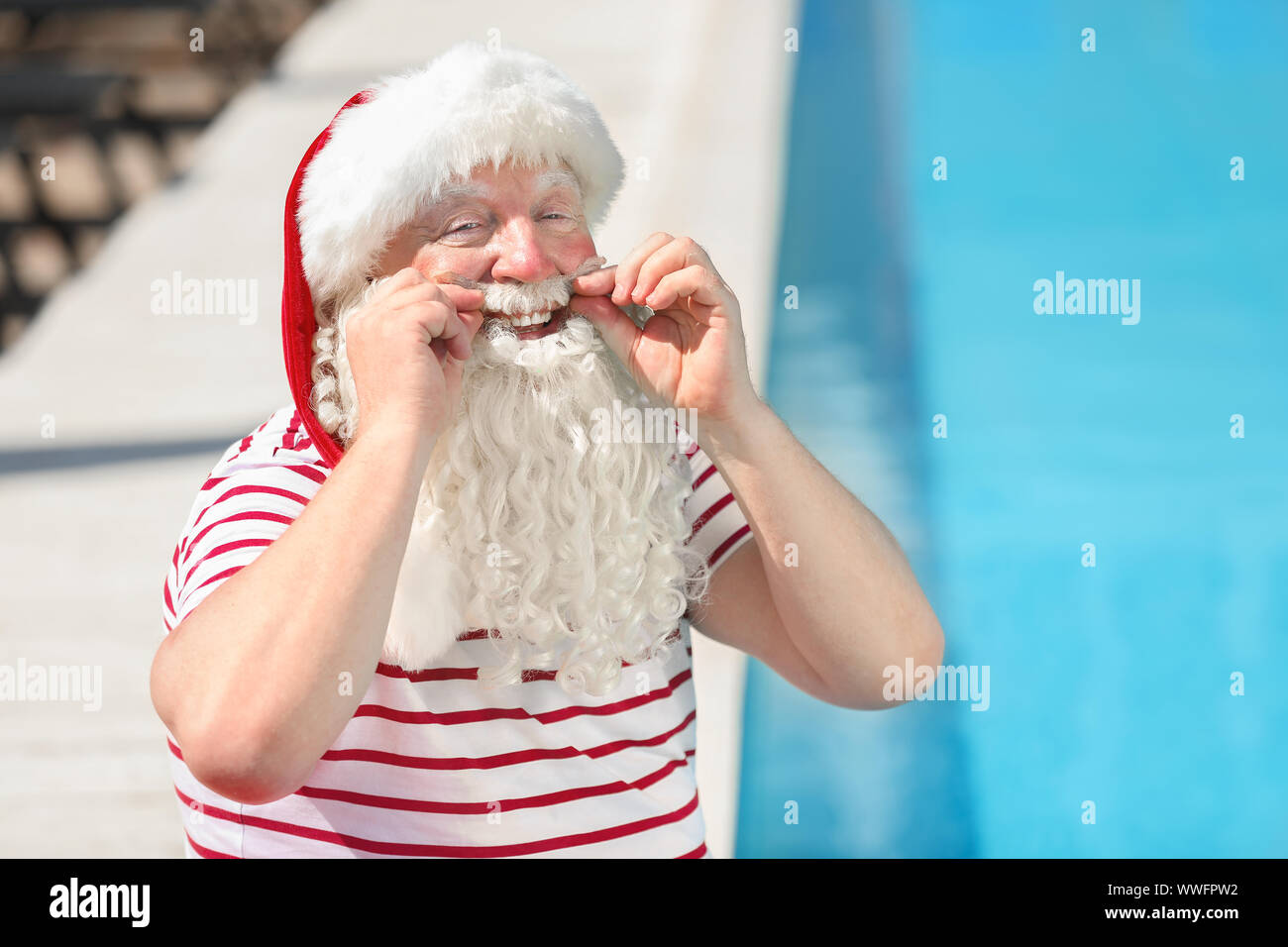 Santa Claus near swimming pool at resort Stock Photo - Alamy