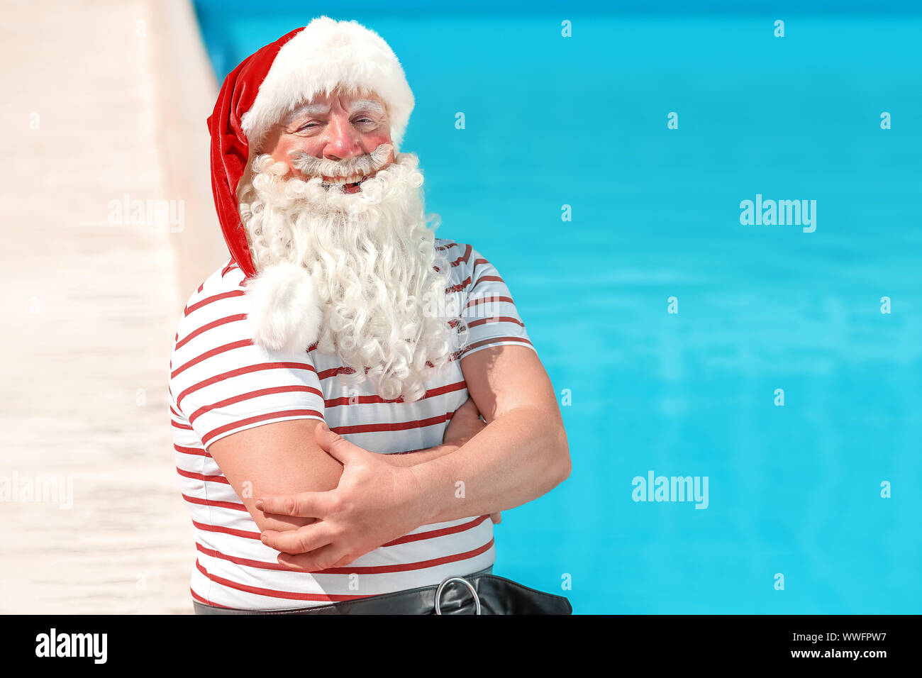 Santa Claus near swimming pool at resort Stock Photo - Alamy