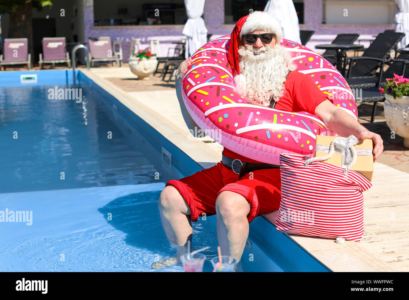Santa Claus with inflatable ring near swimming pool at resort Stock ...