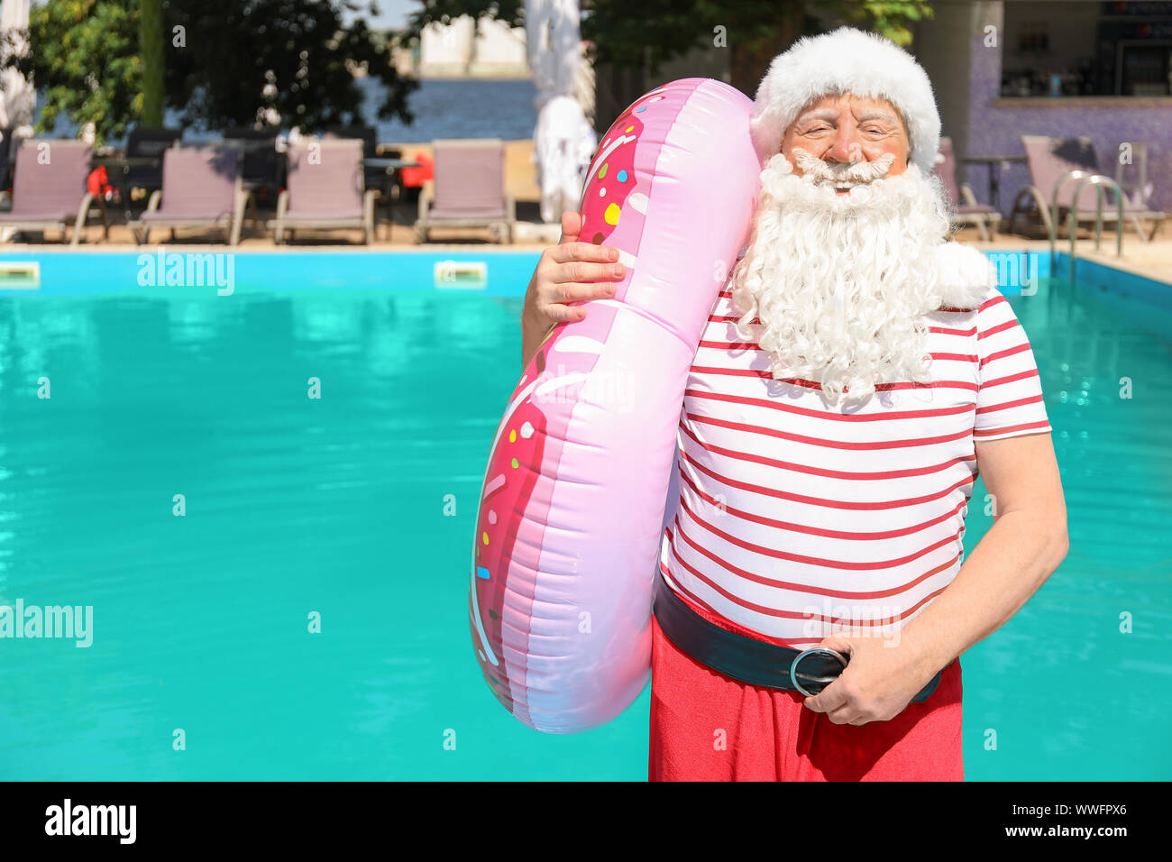 Santa Claus with inflatable ring at resort Stock Photo - Alamy