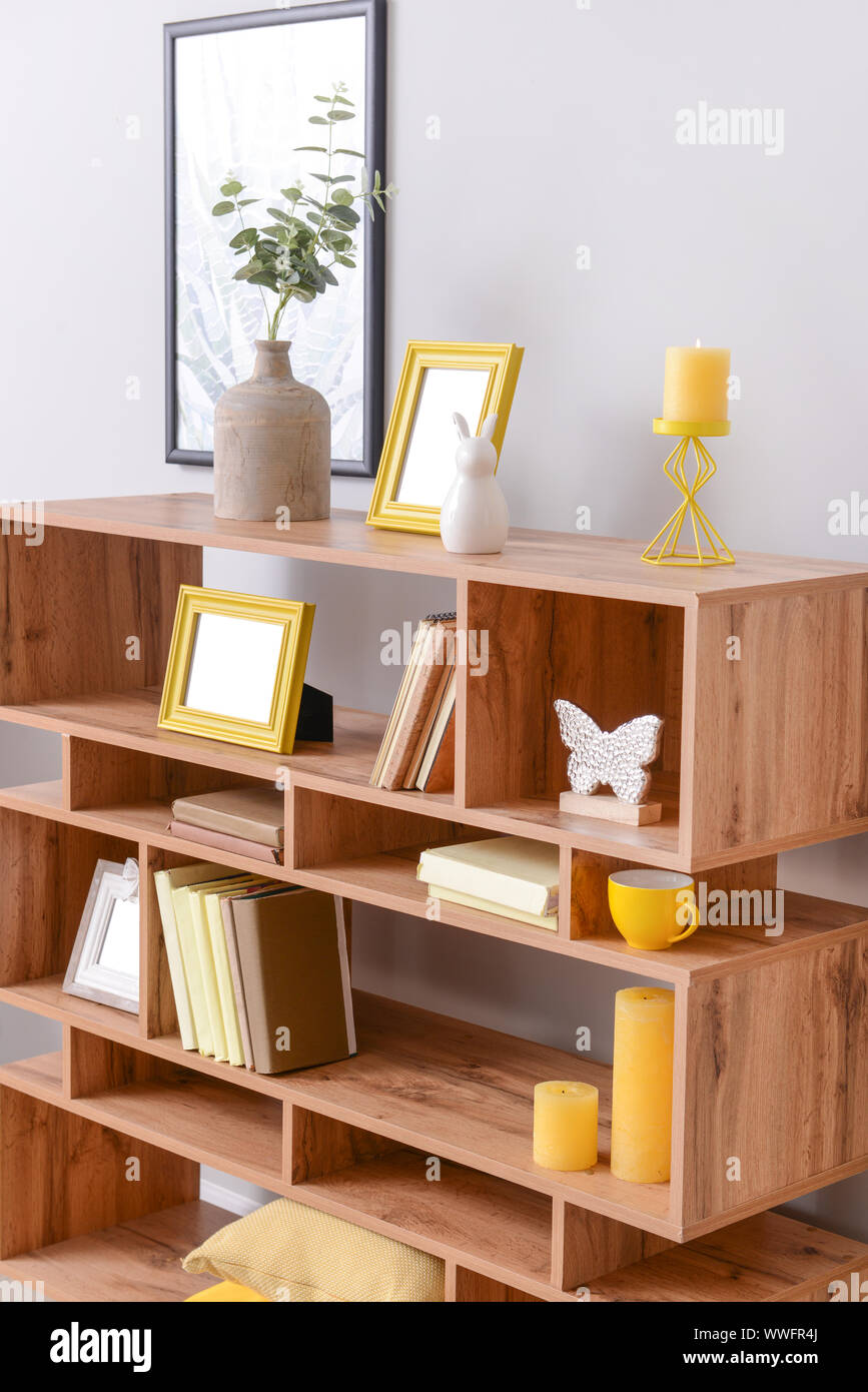 Wooden rack with stylish decor in room Stock Photo - Alamy