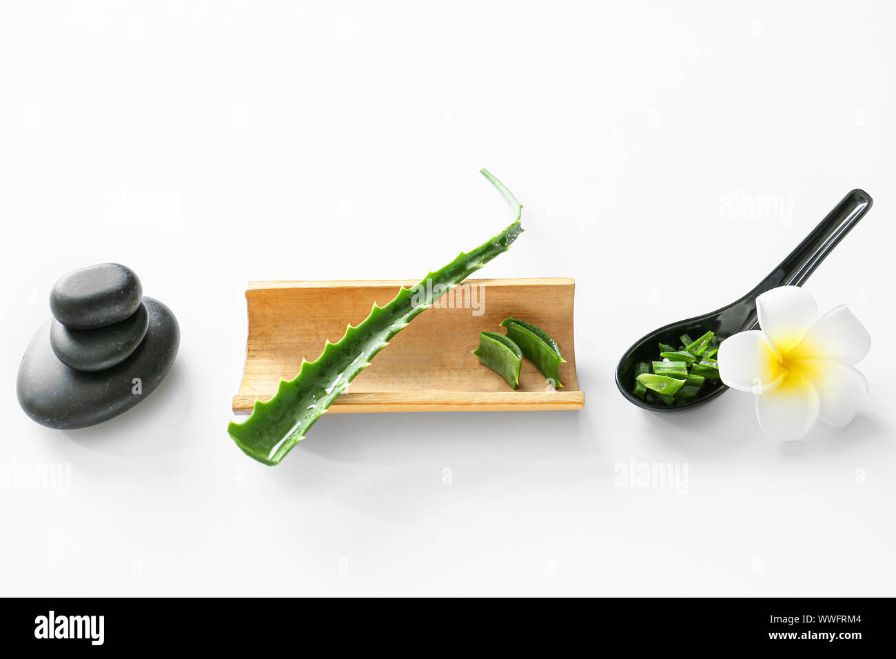 Fresh aloe vera leaves with spa stones on white background Stock Photo ...