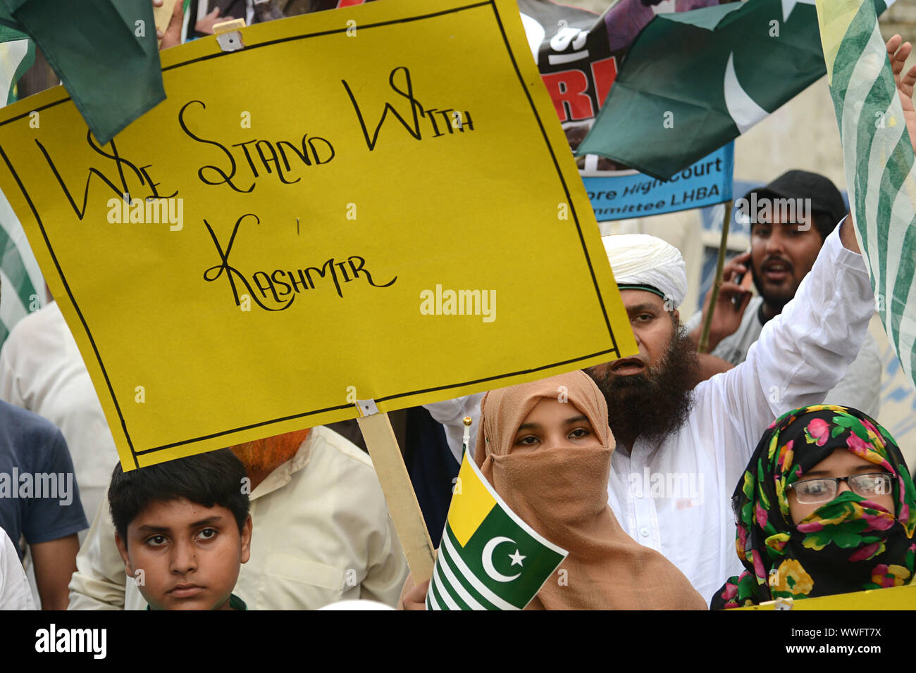 Lahore, Pakistan. 15th Sep, 2019. Pakistani hold placards, banners ...