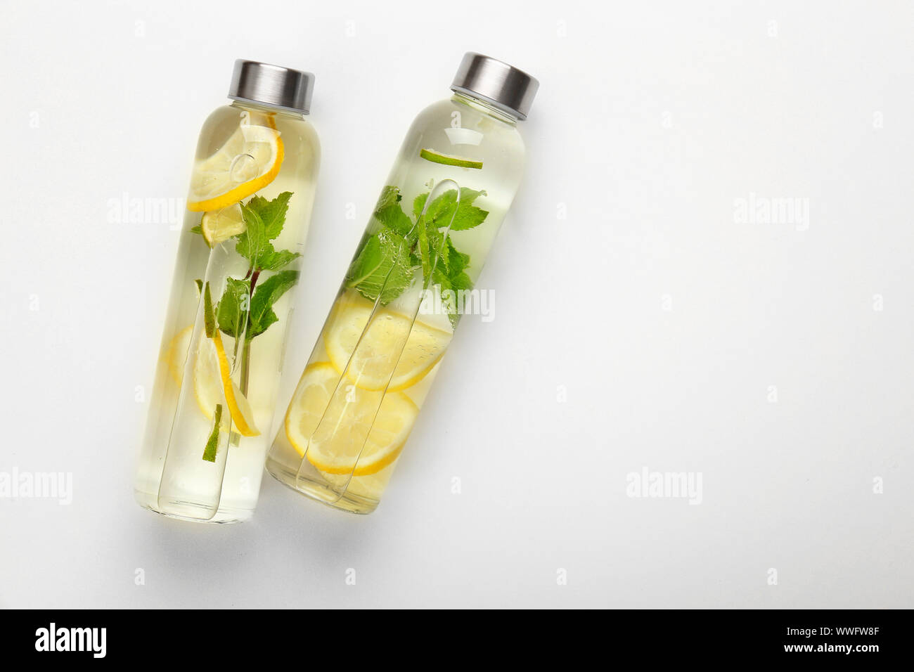 Bottles of fresh infused water on white background Stock Photo - Alamy