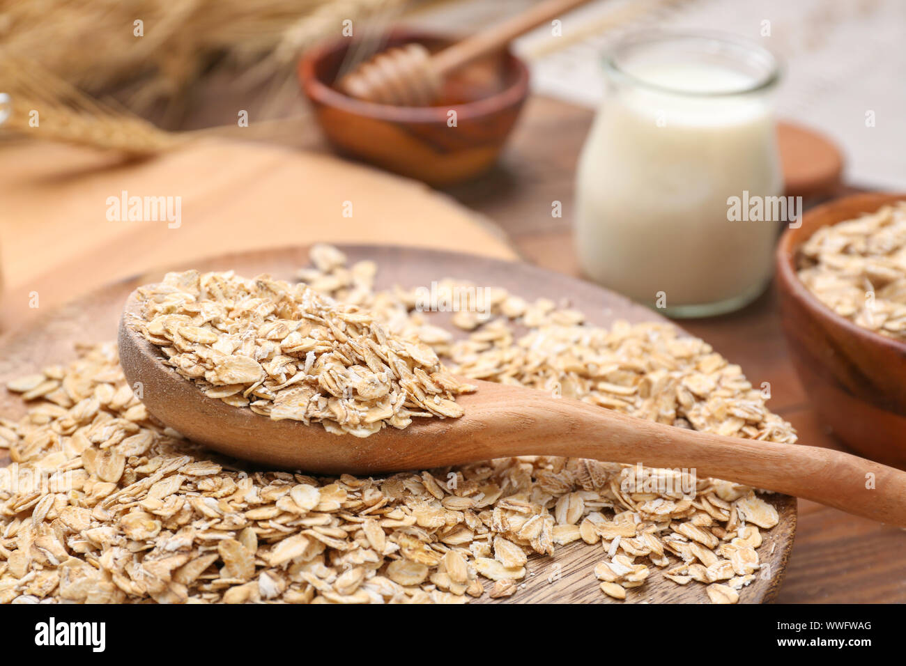 Spoon with oat flakes on plate, closeup Stock Photo - Alamy