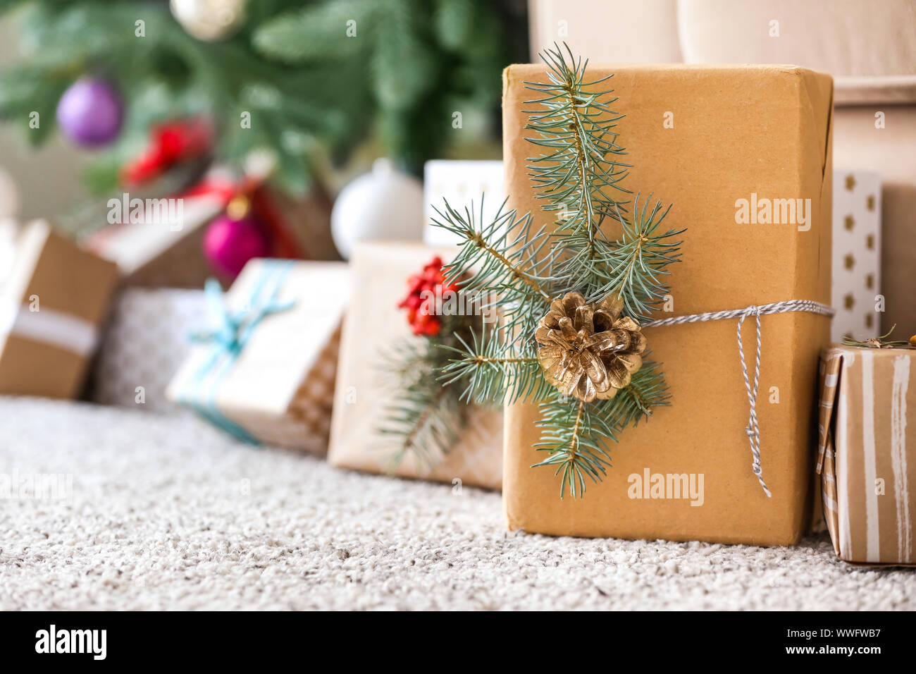 Beautiful gift boxes on floor in room Stock Photo - Alamy