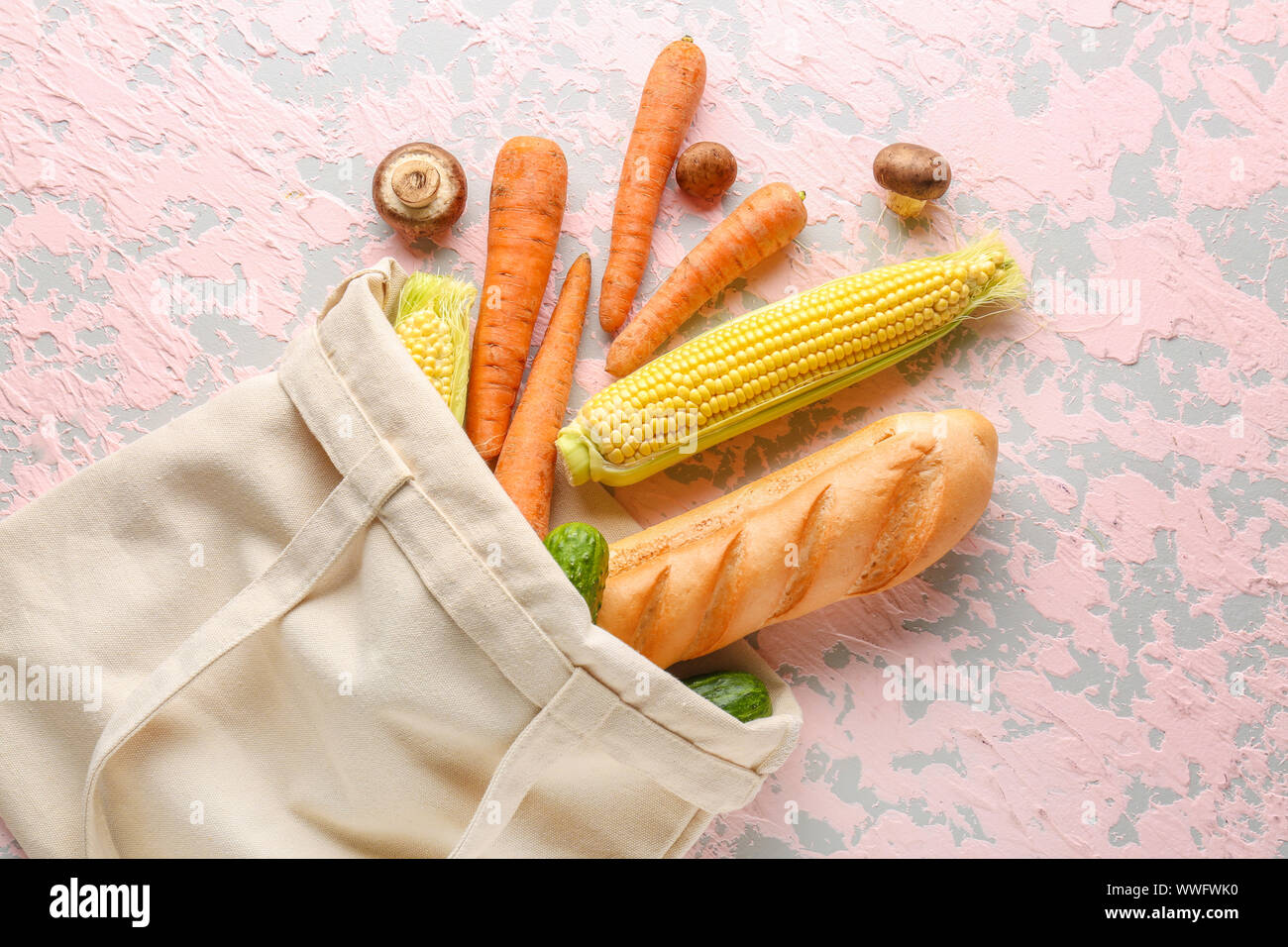 Eco bag with products on color background Stock Photo - Alamy