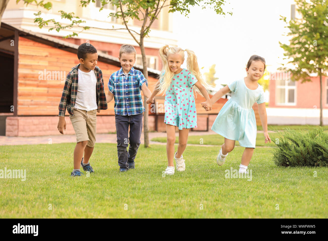 Cute little children running in park Stock Photo - Alamy
