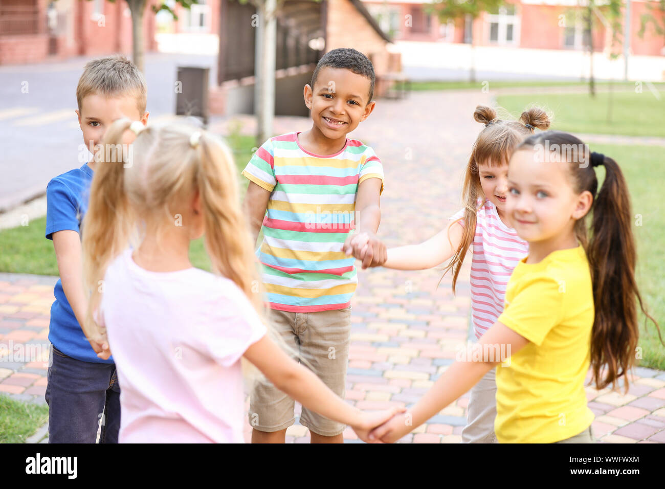 Cute little children doing circle dance outdoors Stock Photo - Alamy