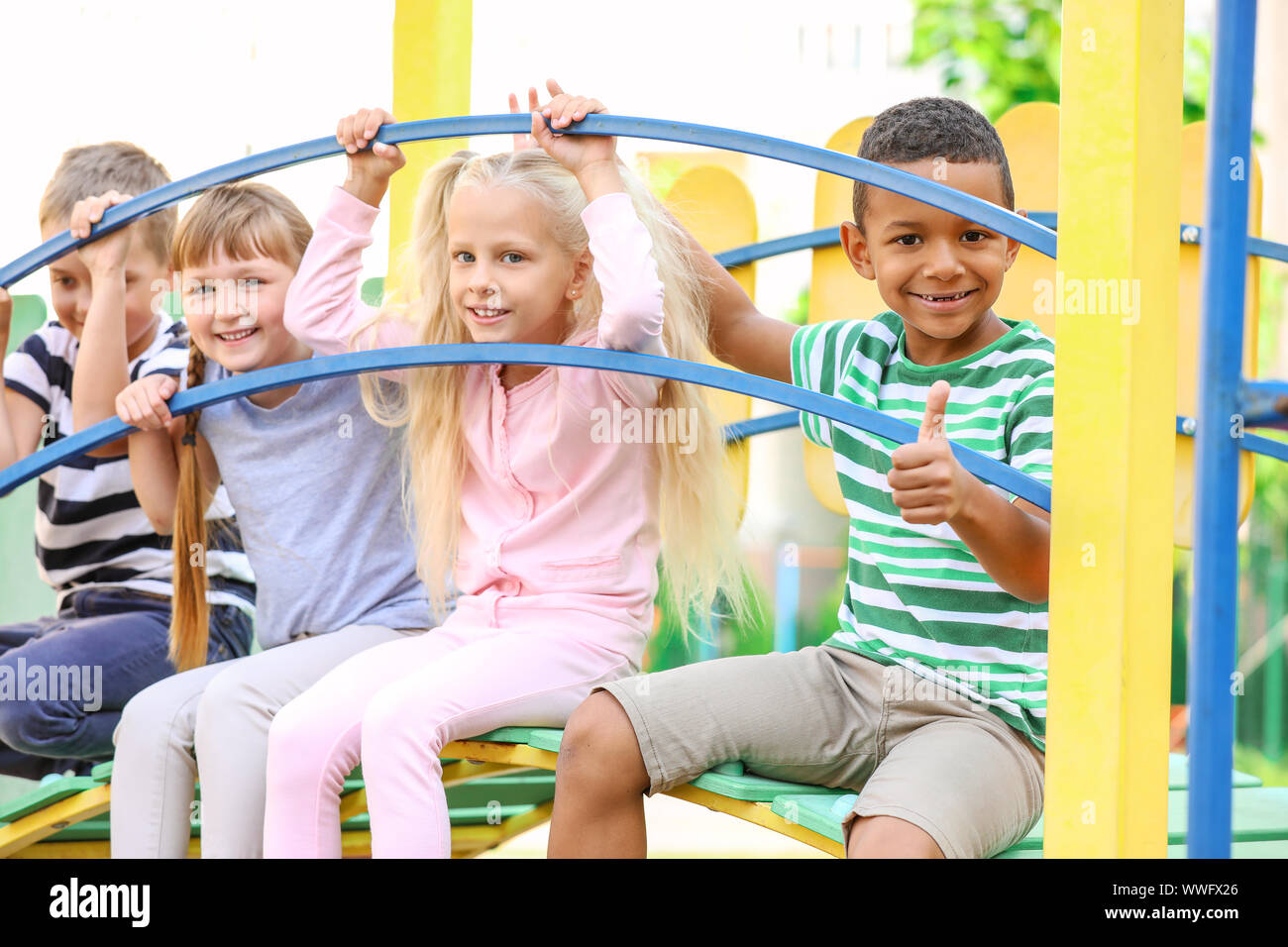 Cute little children on playground Stock Photo - Alamy