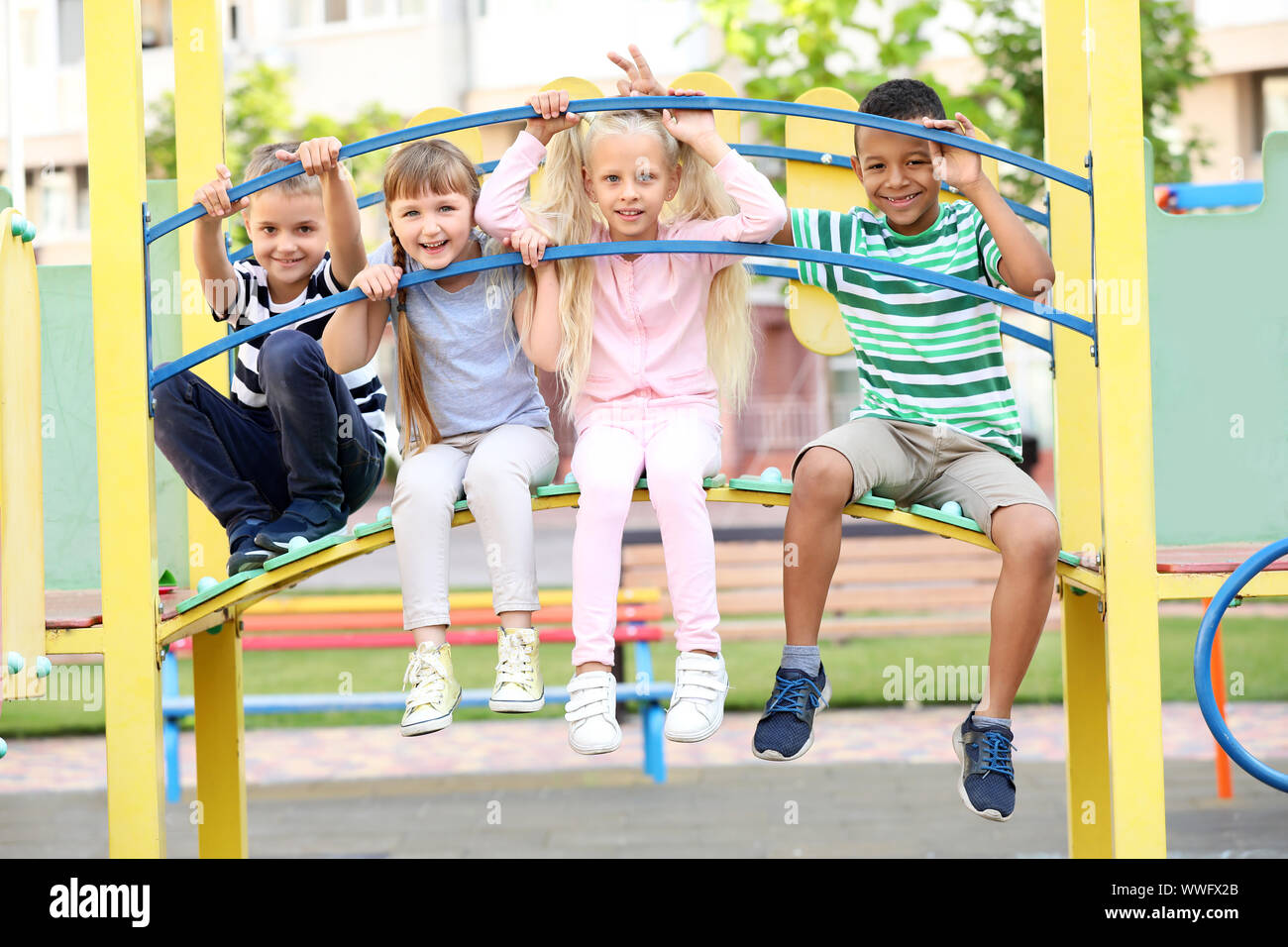 Cute little children on playground Stock Photo - Alamy