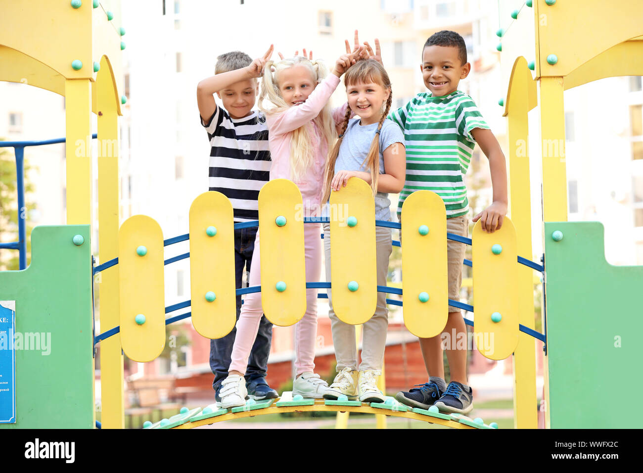 Cute little children on playground Stock Photo - Alamy