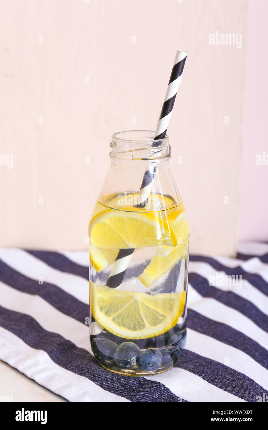 Bottle of tasty infused water on table Stock Photo - Alamy