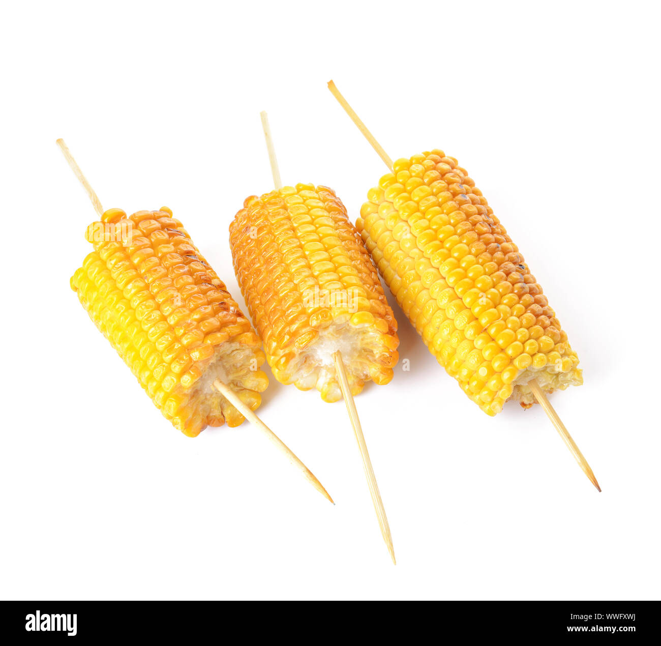 Sticks with tasty grilled corn cobs on white background Stock Photo - Alamy