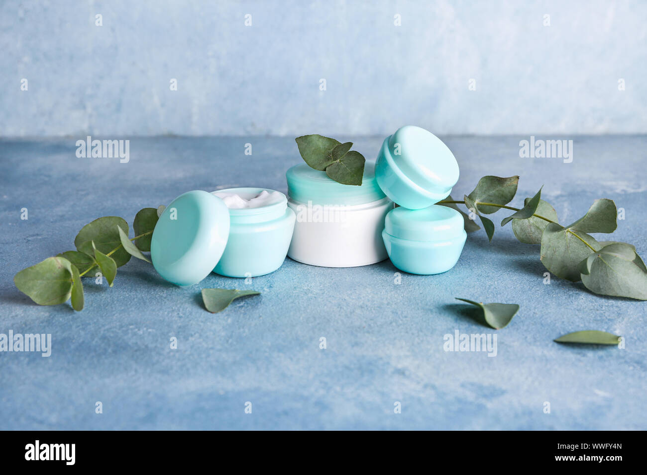 Body cream with eucalyptus on color background Stock Photo - Alamy