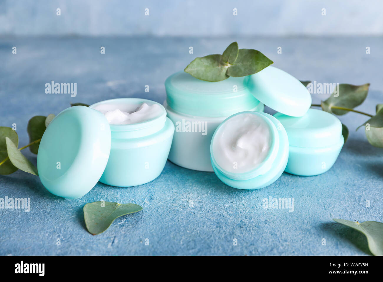 Body cream with eucalyptus on color background Stock Photo - Alamy