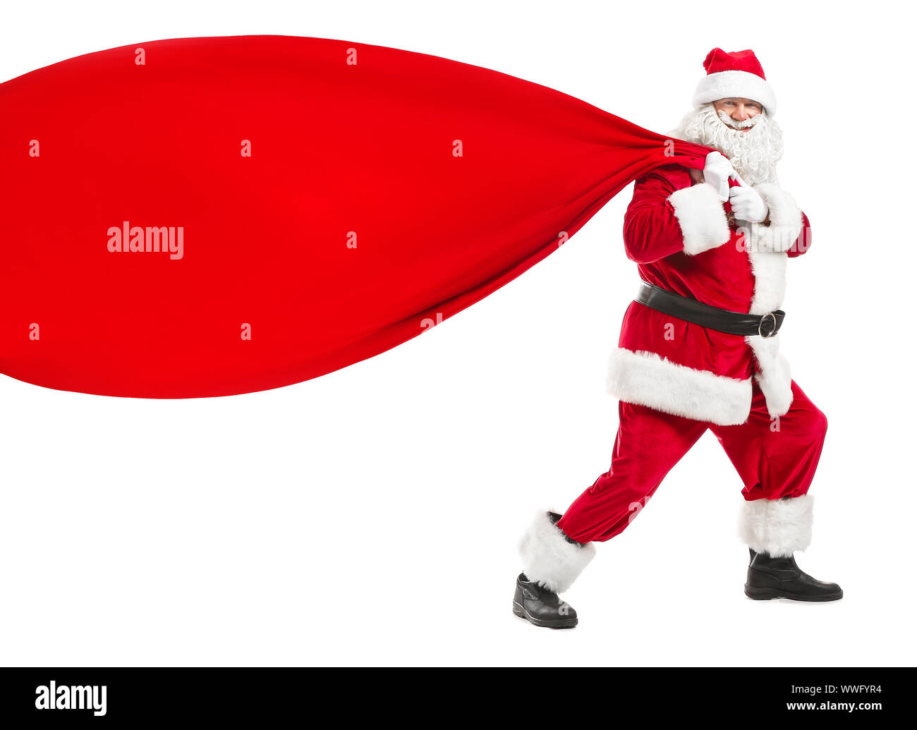 Portrait of Santa Claus pulling big bag on white background Stock Photo ...