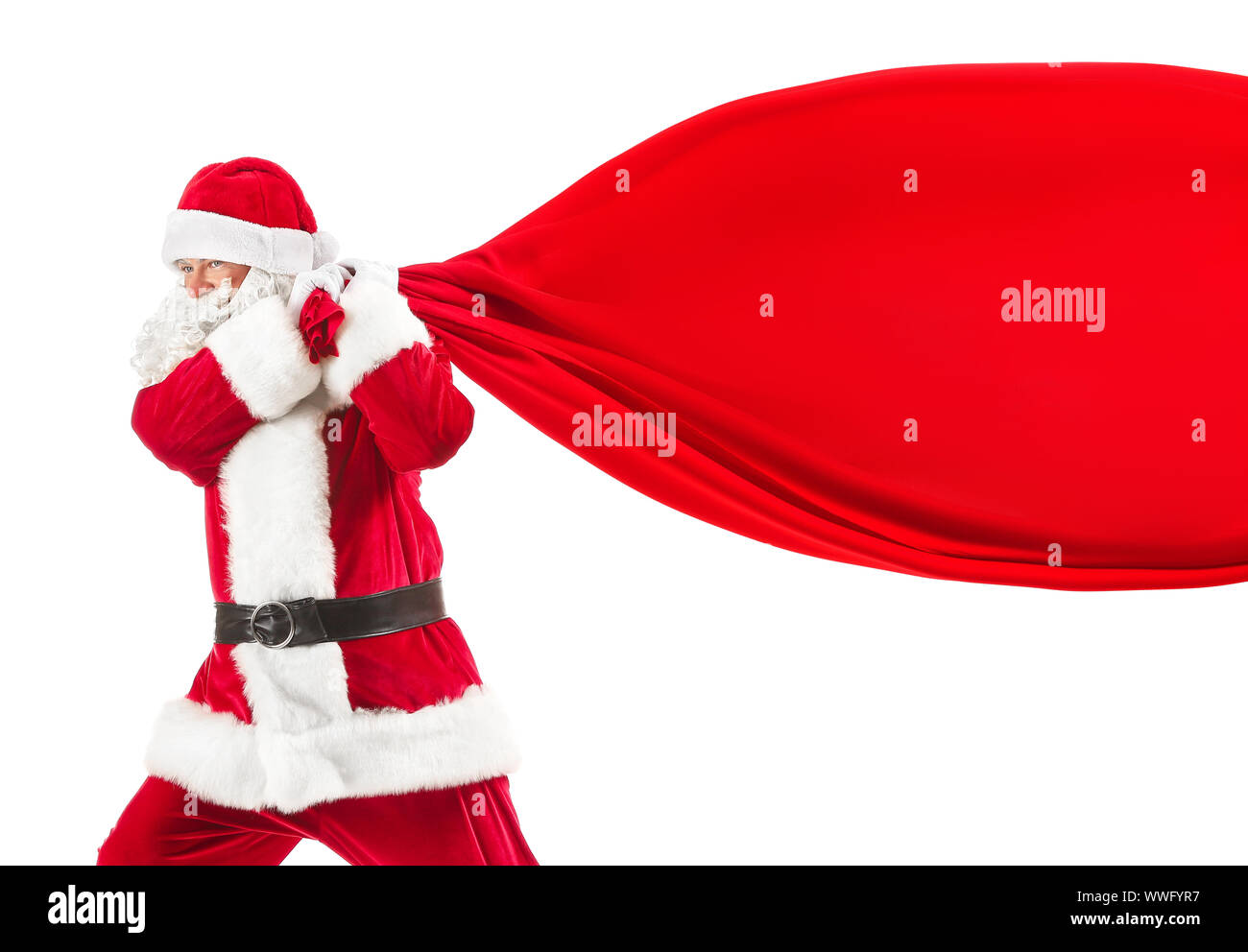 Portrait of Santa Claus pulling big bag on white background Stock Photo ...