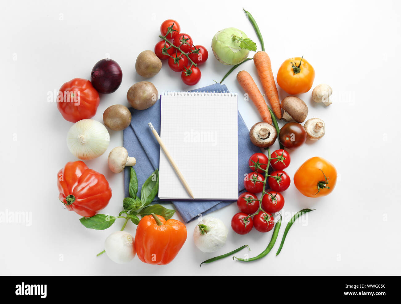 Different fresh vegetables with notebook on white background Stock ...