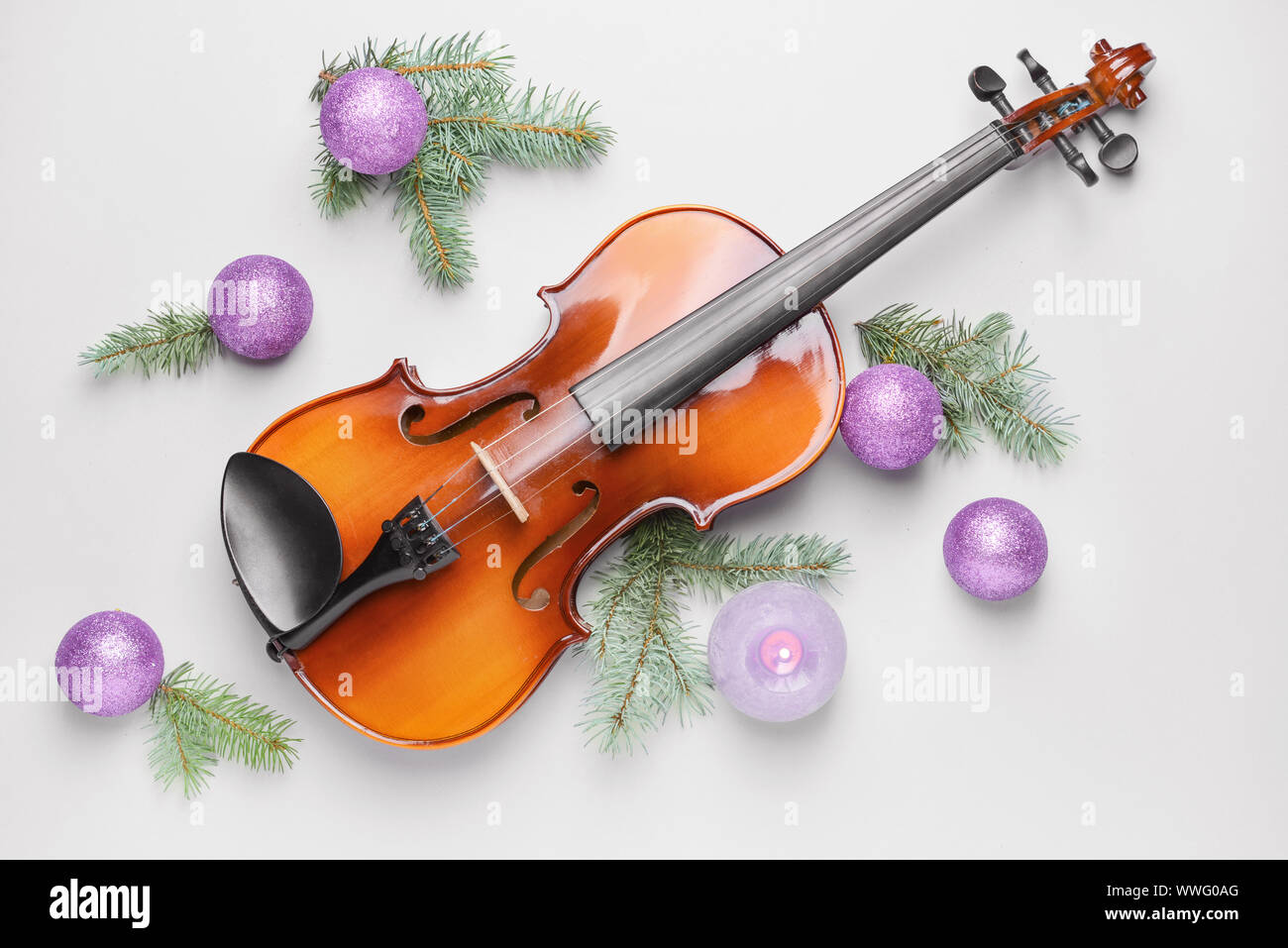 Violin and Christmas decor on light background Stock Photo - Alamy