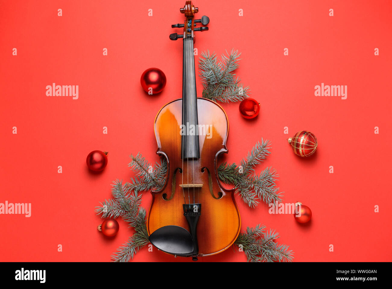 Violin and Christmas decor on color background Stock Photo - Alamy