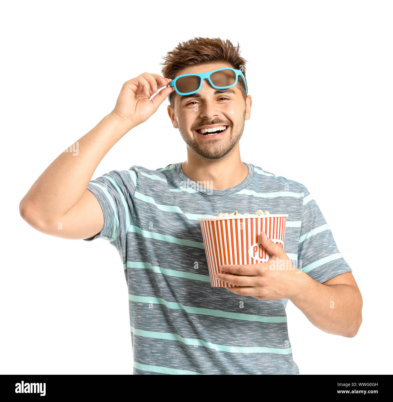 Young man with popcorn on white background Stock Photo - Alamy