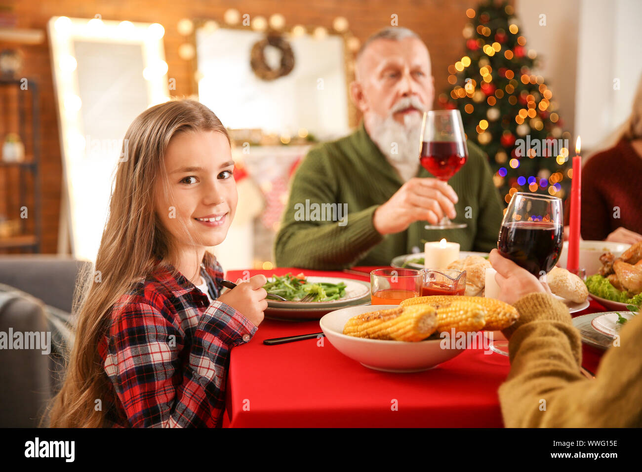 Happy little girl with her family having Christmas dinner at home Stock ...