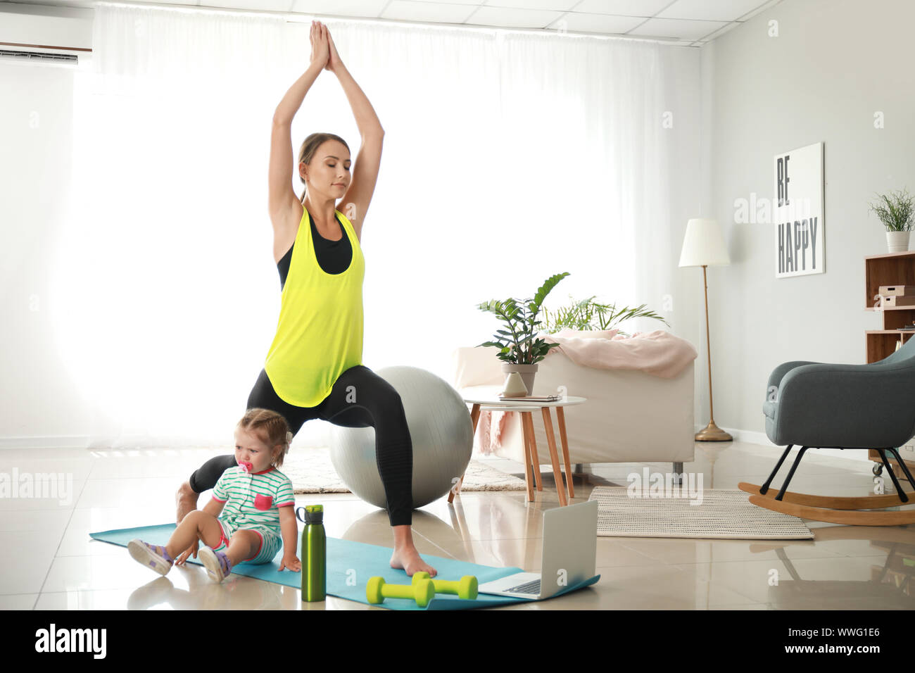 Sporty mother with little daughter training at home Stock Photo - Alamy