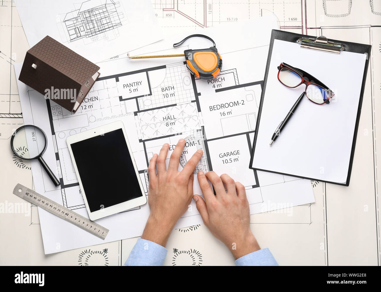 Male architect working at table, top view Stock Photo - Alamy
