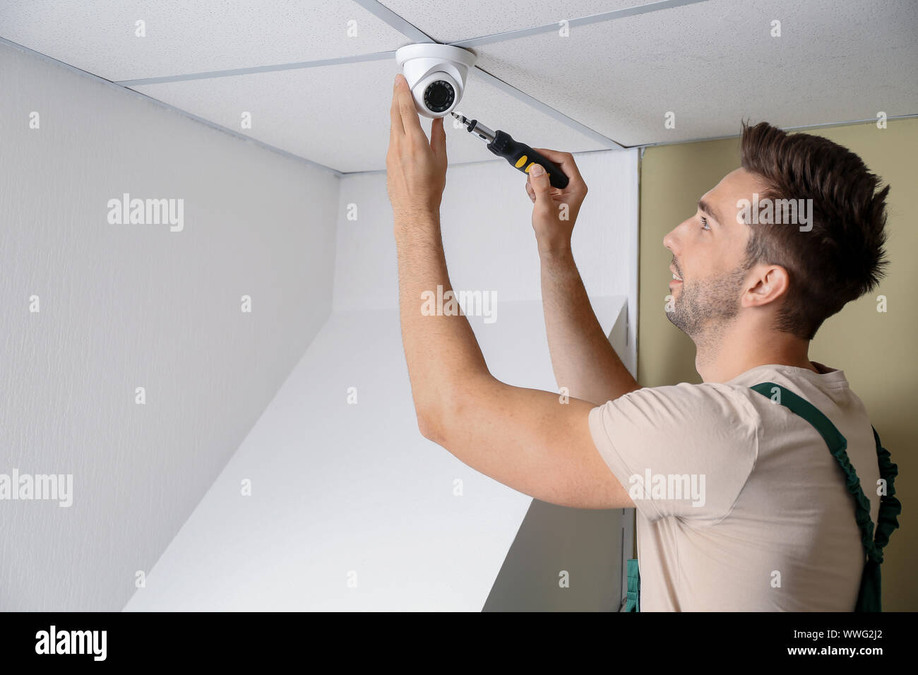Electrician installing alarm system indoors Stock Photo - Alamy
