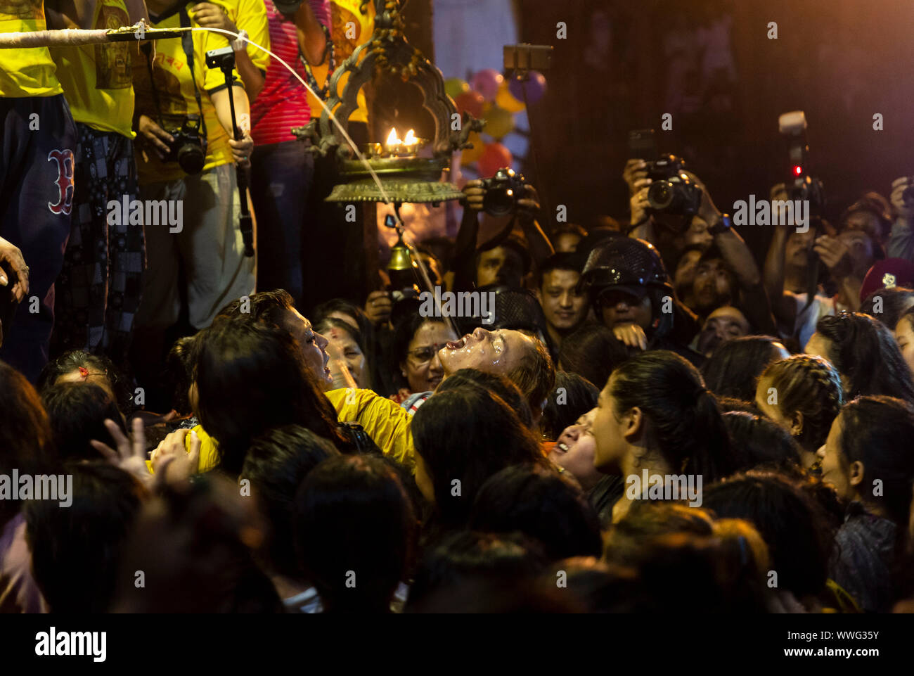 Kathmandu, Nepal. 15th Sep, 2019. A Nepalese girl is being helped to ...