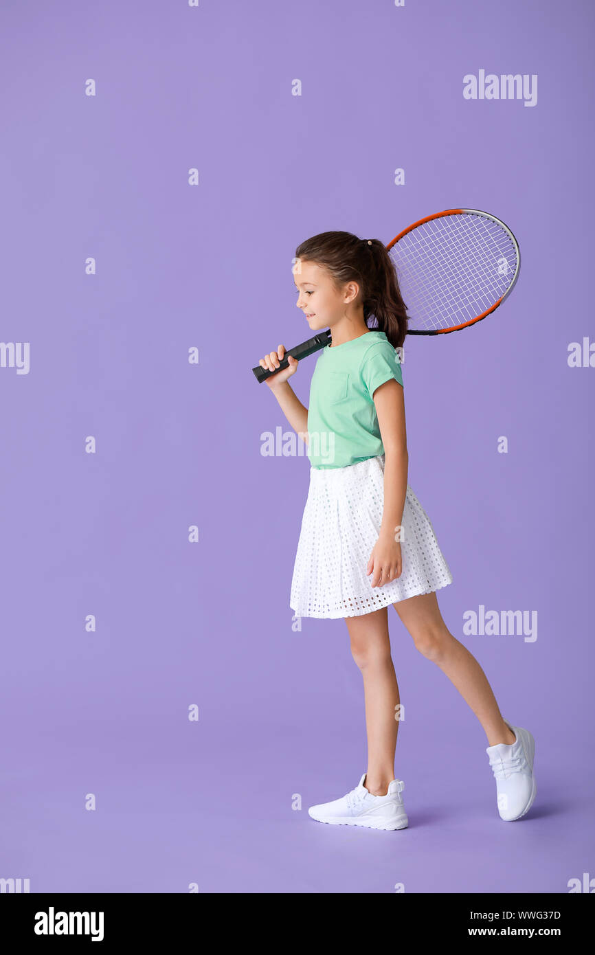 Little girl with tennis racket on color background Stock Photo - Alamy