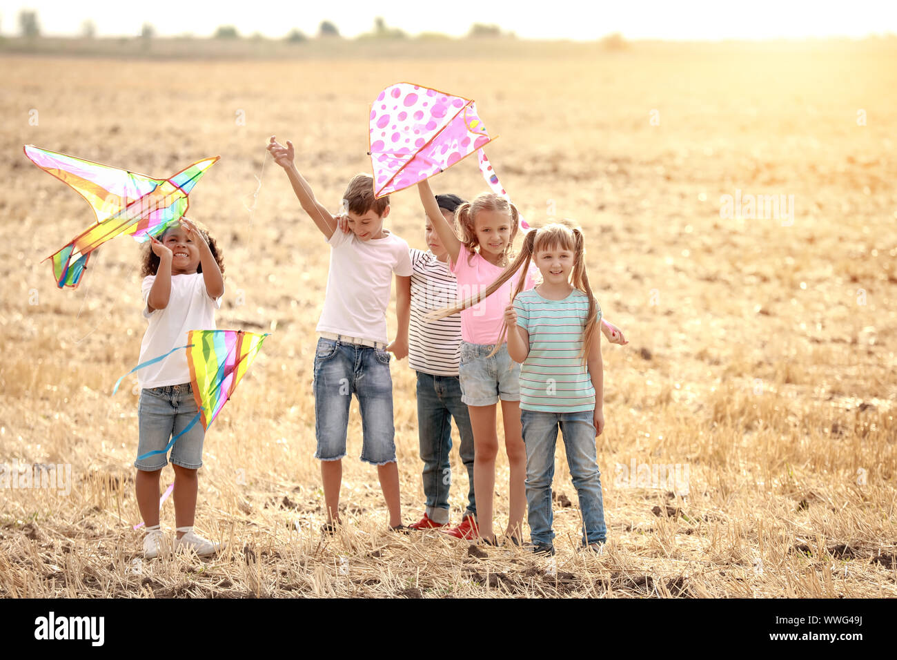 Little children flying kites outdoors Stock Photo - Alamy