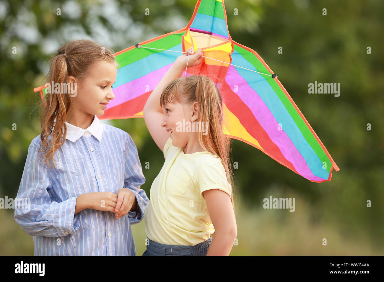 Little girls flying kite outdoors Stock Photo - Alamy