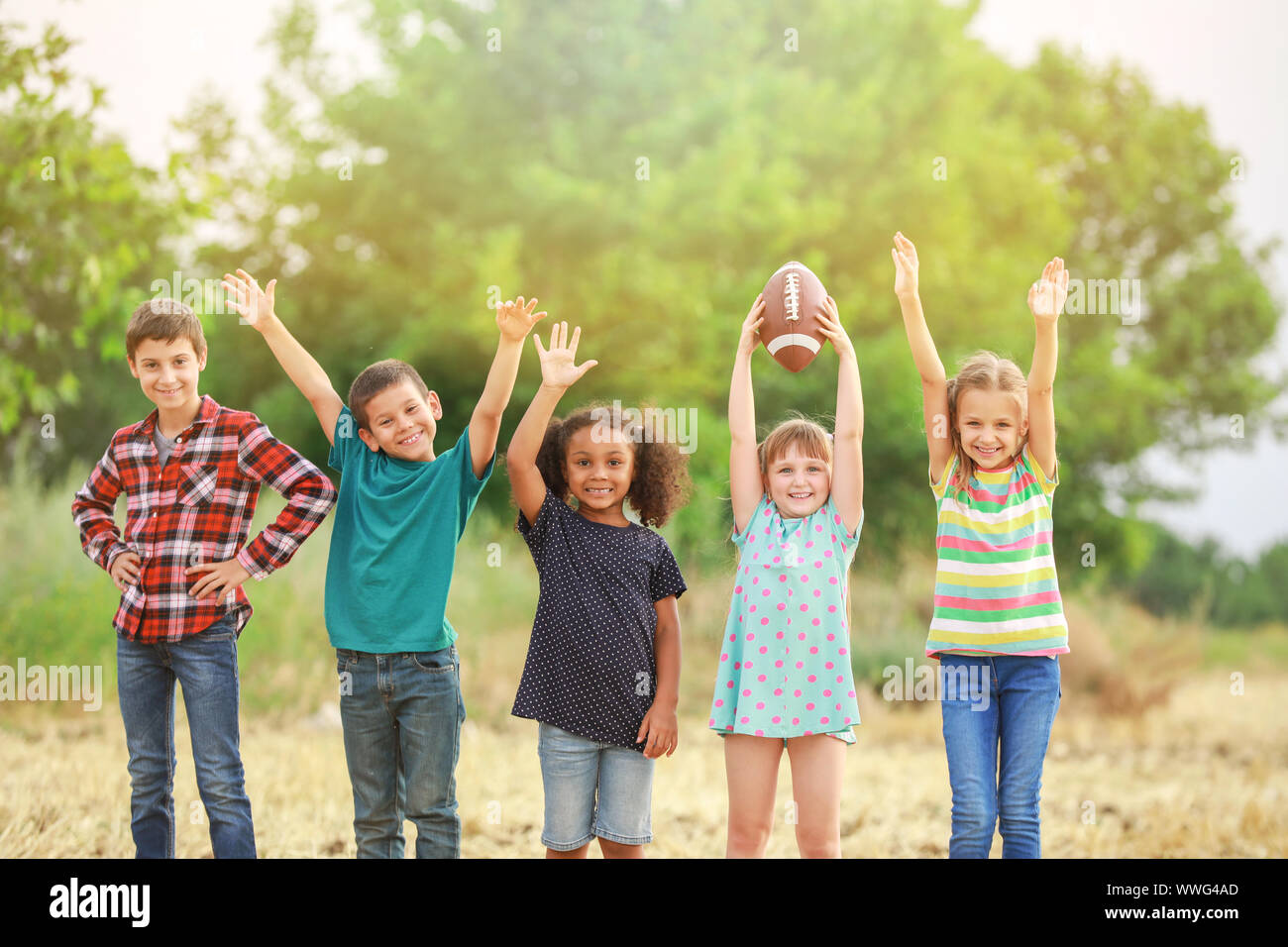 Cute little children with rugby ball outdoors Stock Photo - Alamy