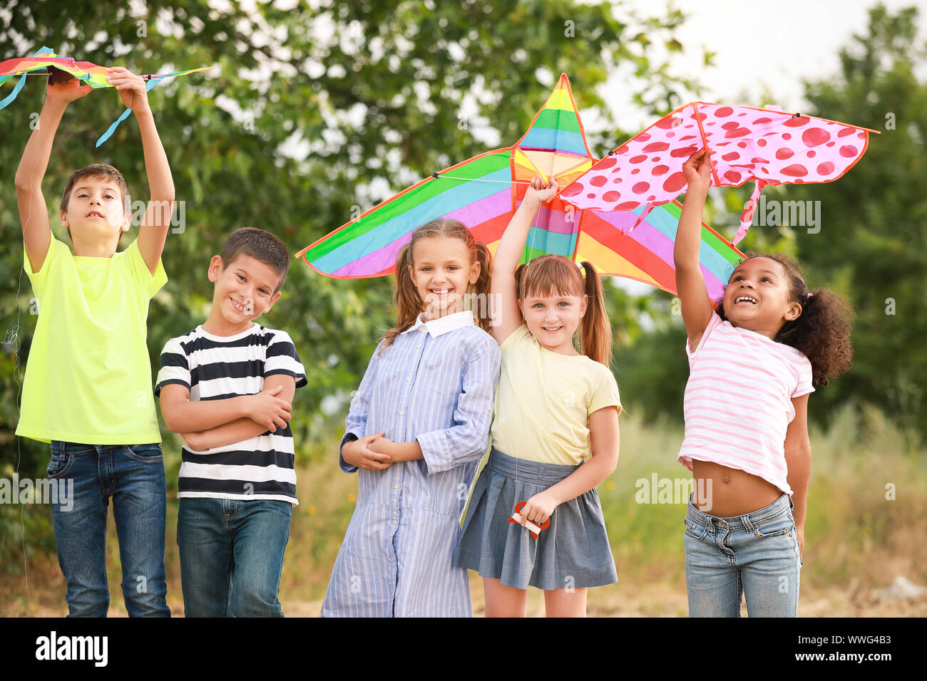 Little children flying kites outdoors Stock Photo - Alamy