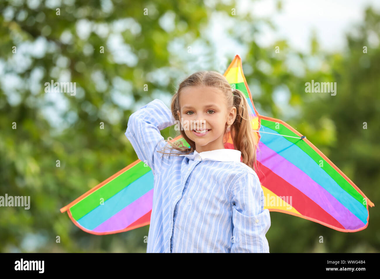 Little girl flying kite outdoors Stock Photo - Alamy