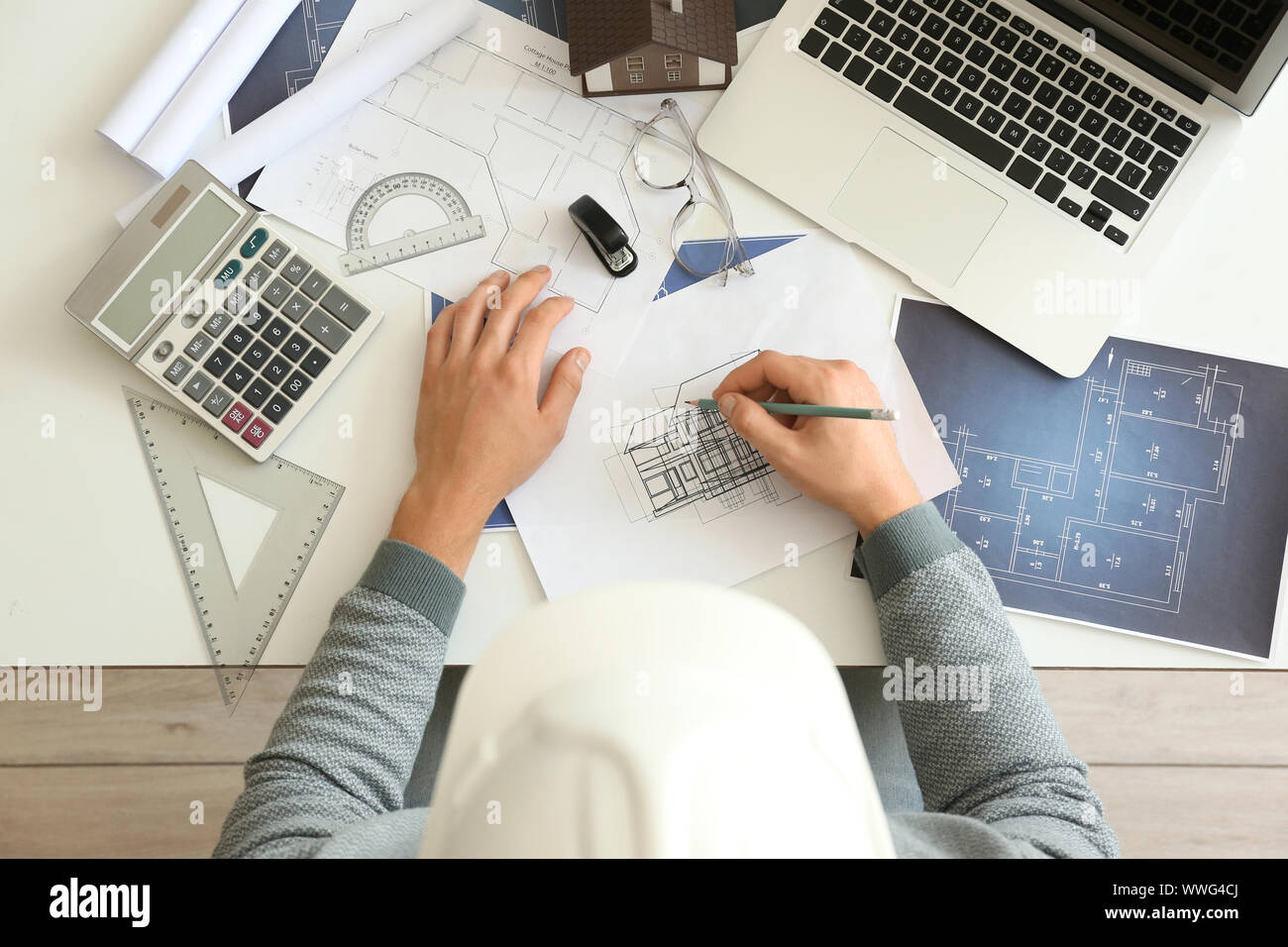 Architect working on project of building in office Stock Photo - Alamy