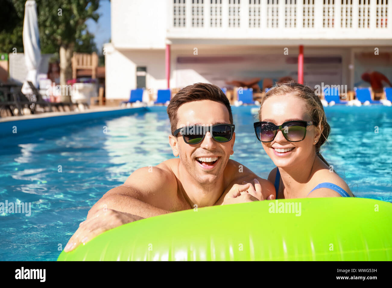 Happy young couple in swimming pool Stock Photo - Alamy