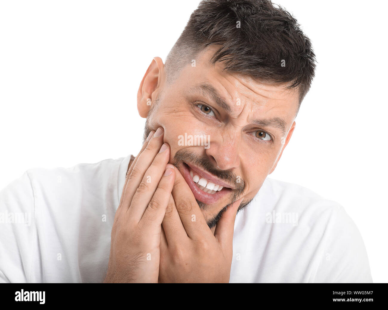 Man suffering from toothache against white background Stock Photo - Alamy