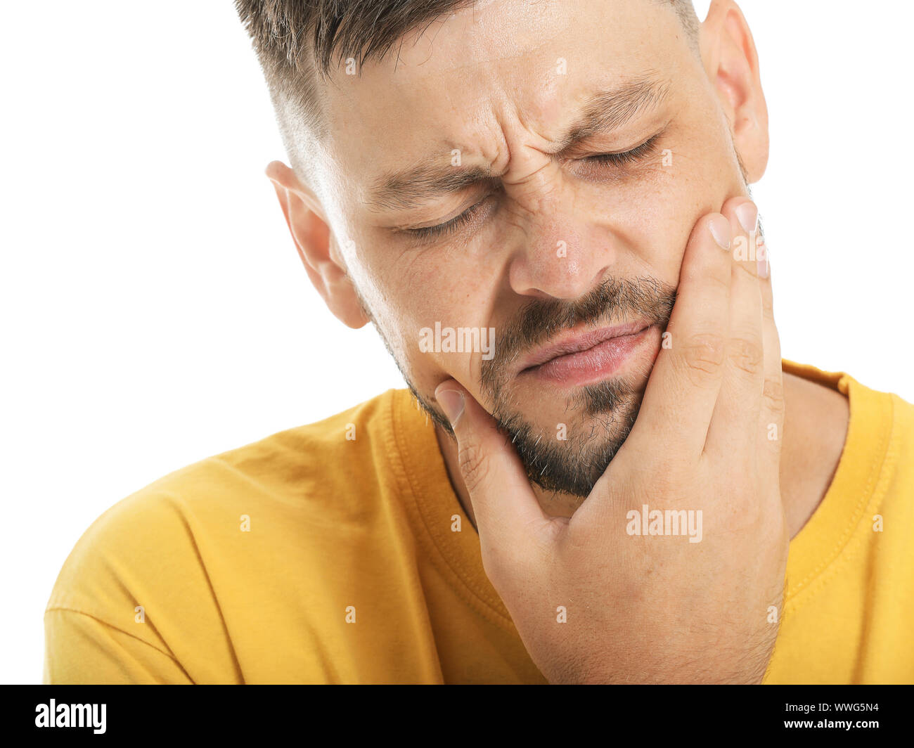 Man suffering from toothache against white background Stock Photo - Alamy