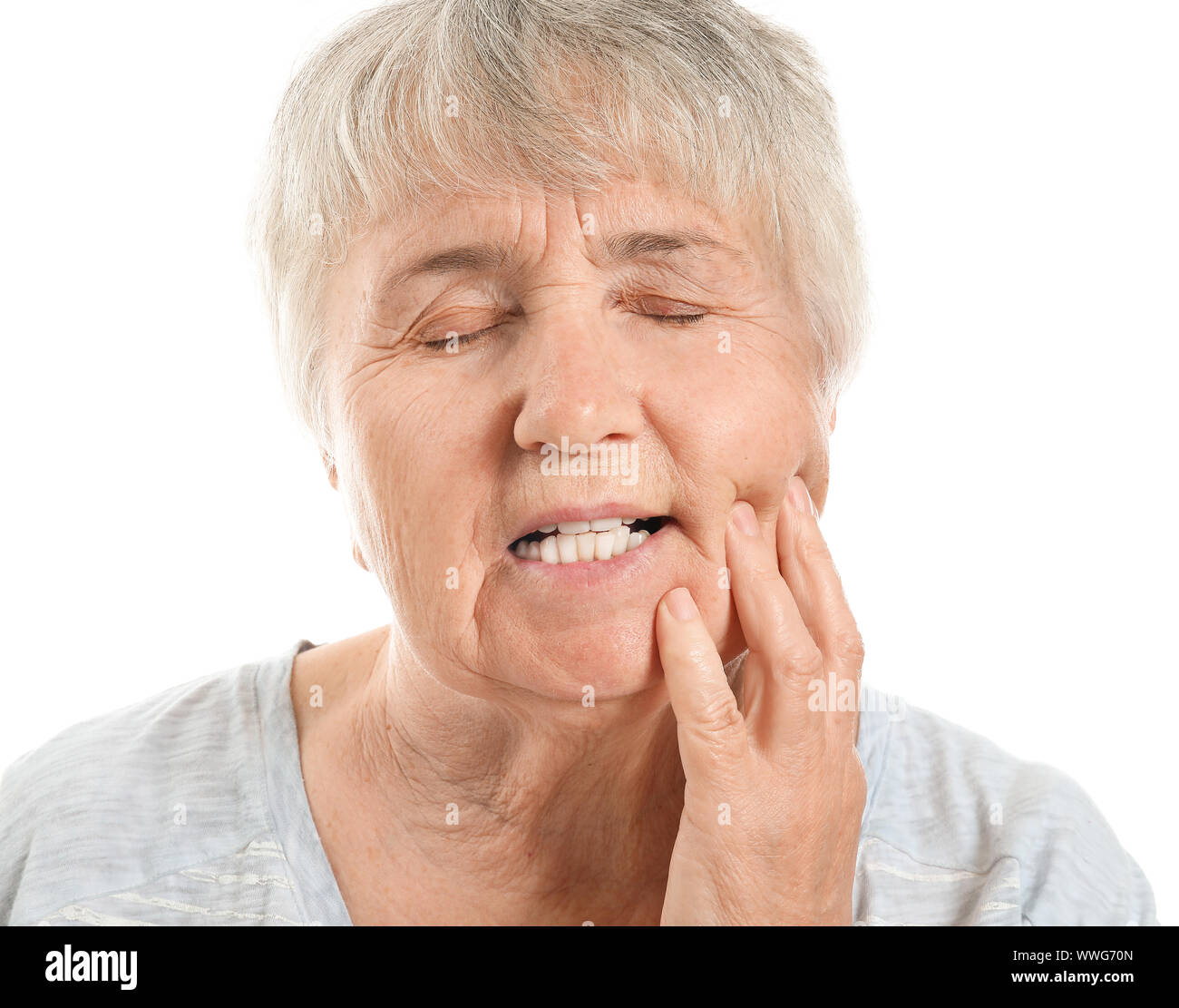 Senior woman suffering from toothache against white background Stock ...