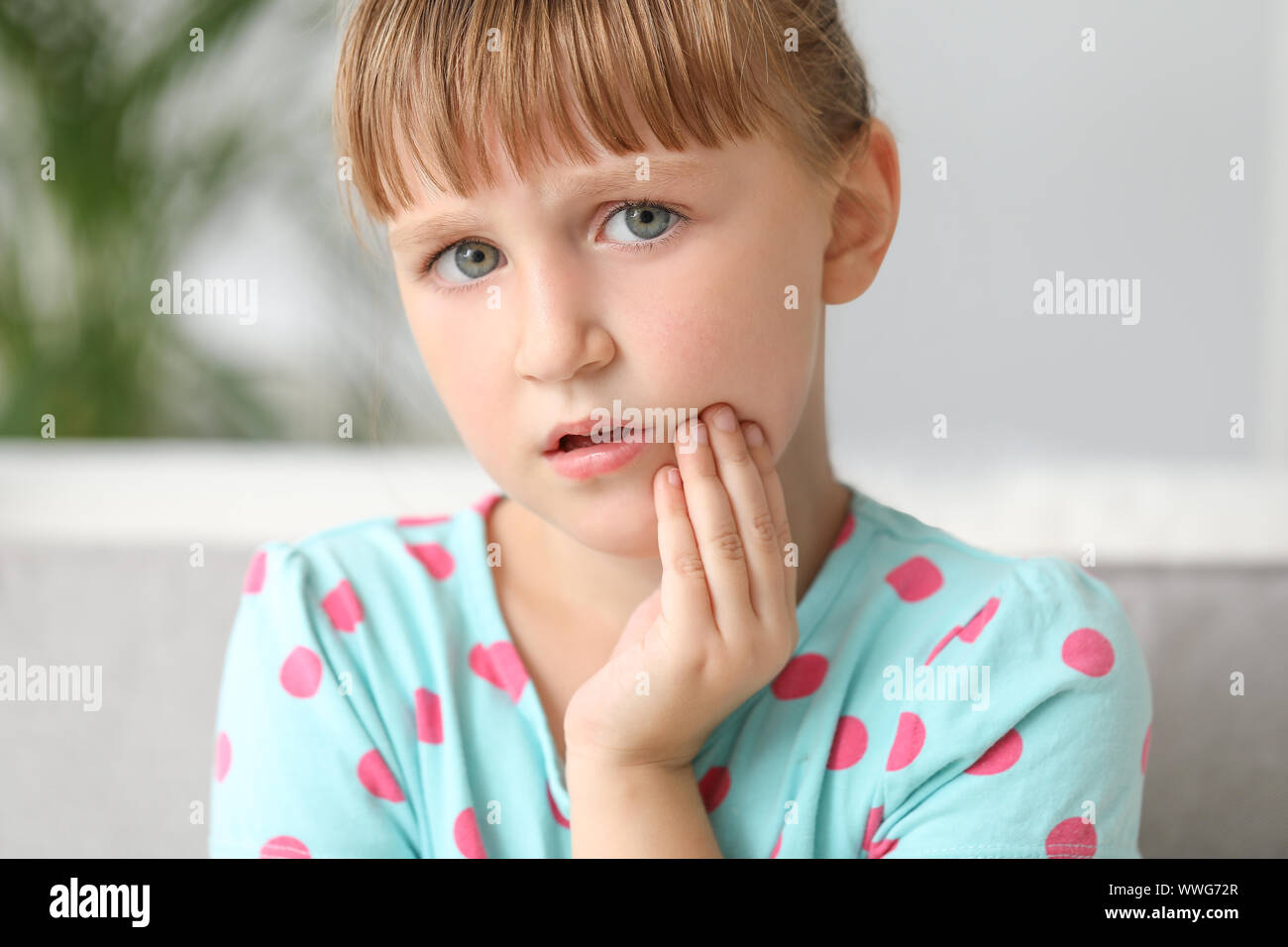 Little girl suffering from toothache at home Stock Photo - Alamy