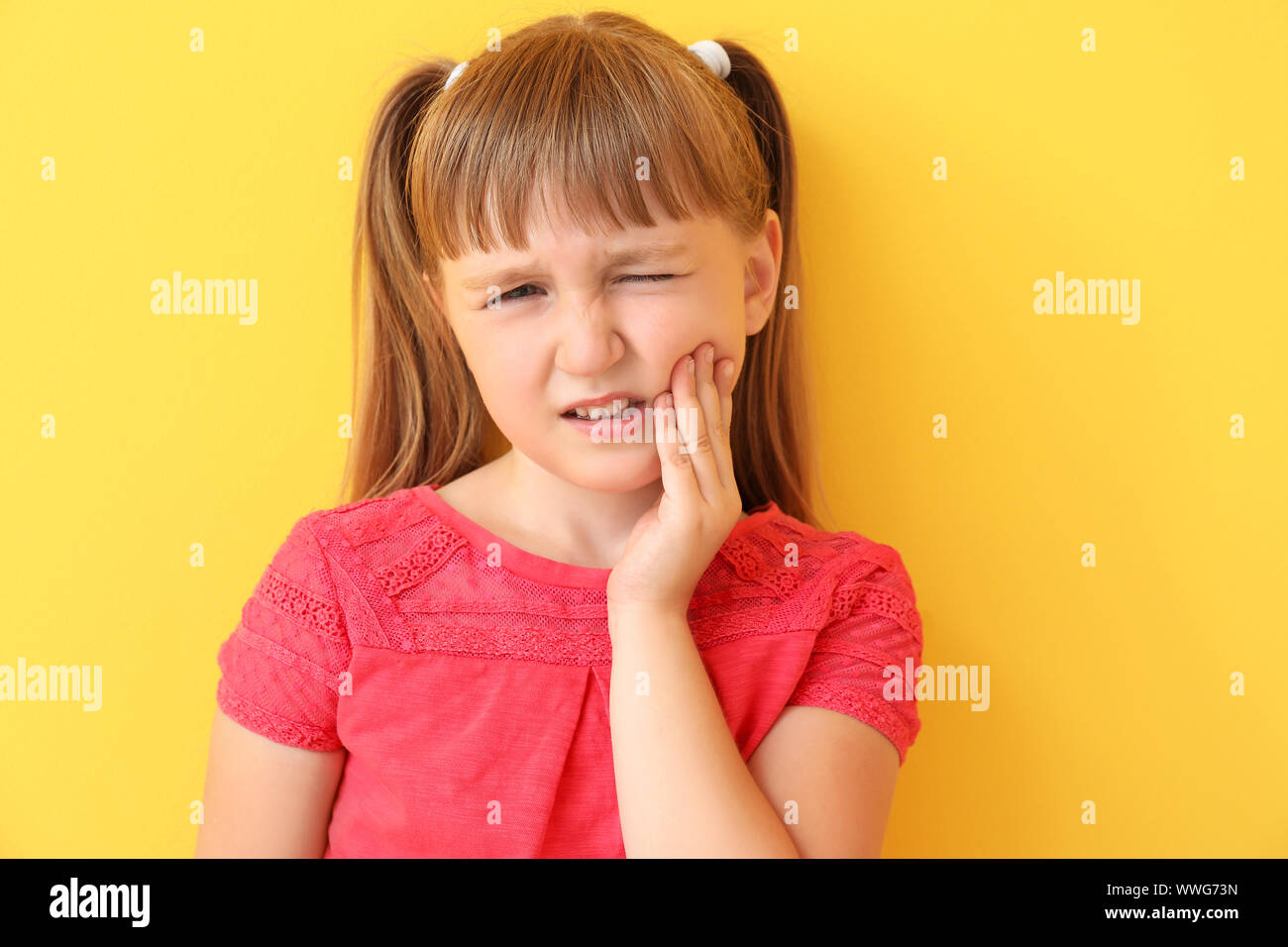 Little girl suffering from toothache on color background Stock Photo ...