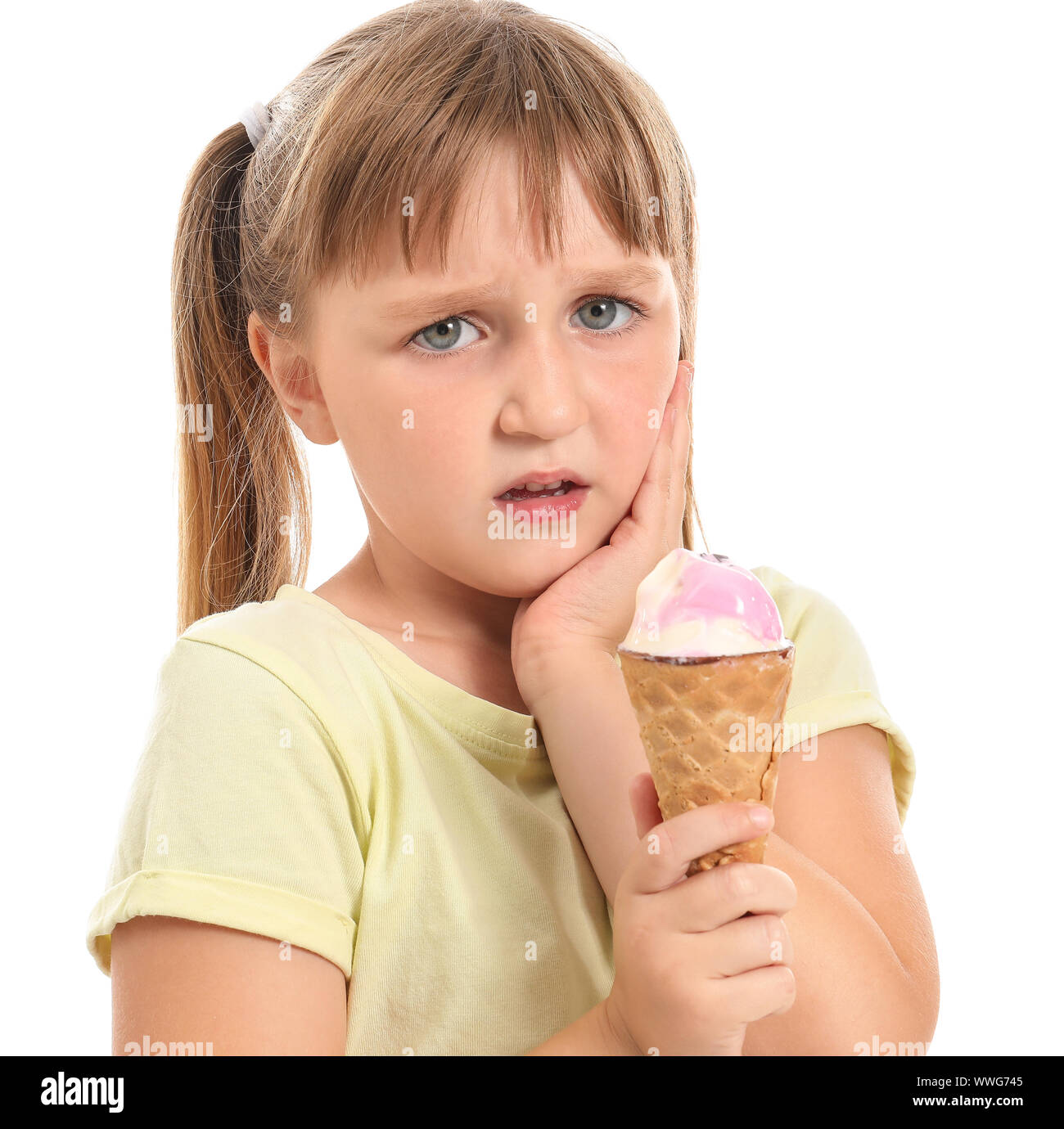 Little girl with sensitive teeth and cold ice-cream on white background ...