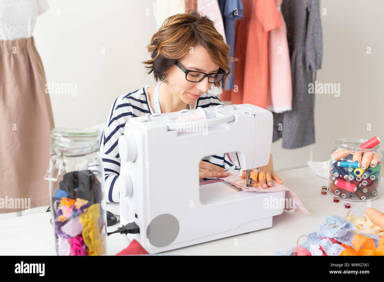 clothing designer, seamstress, people concept - clothing designer ...