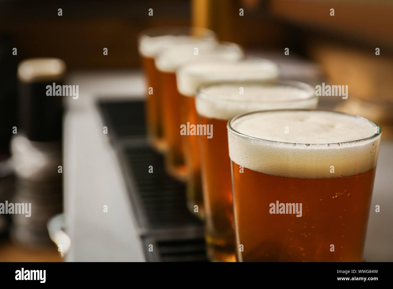 Glasses of fresh draft beer on bar counter Stock Photo - Alamy