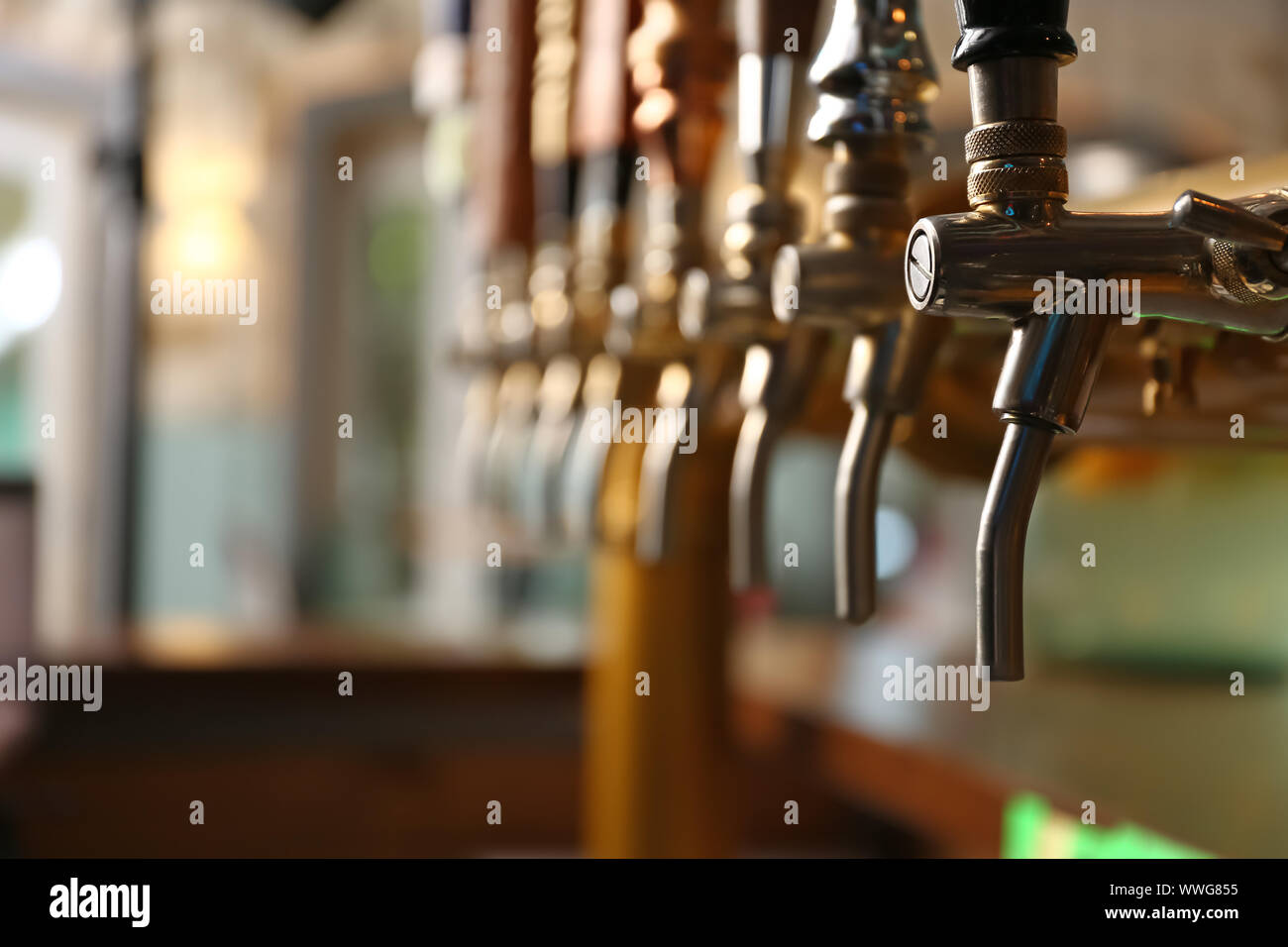 Draft beer taps in modern bar Stock Photo - Alamy